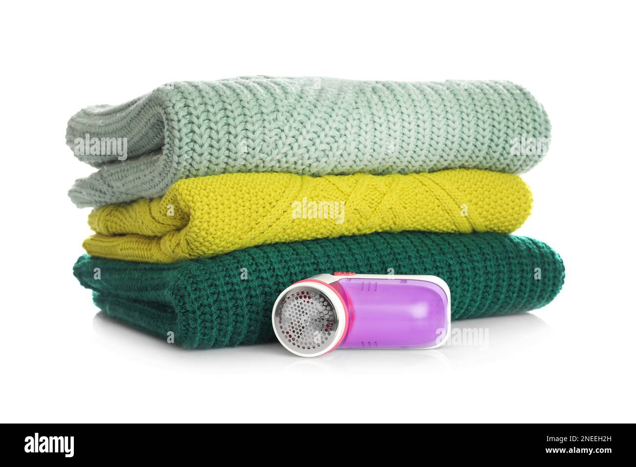 Modern fabric shaver and woolen clothes on white background Stock Photo ...