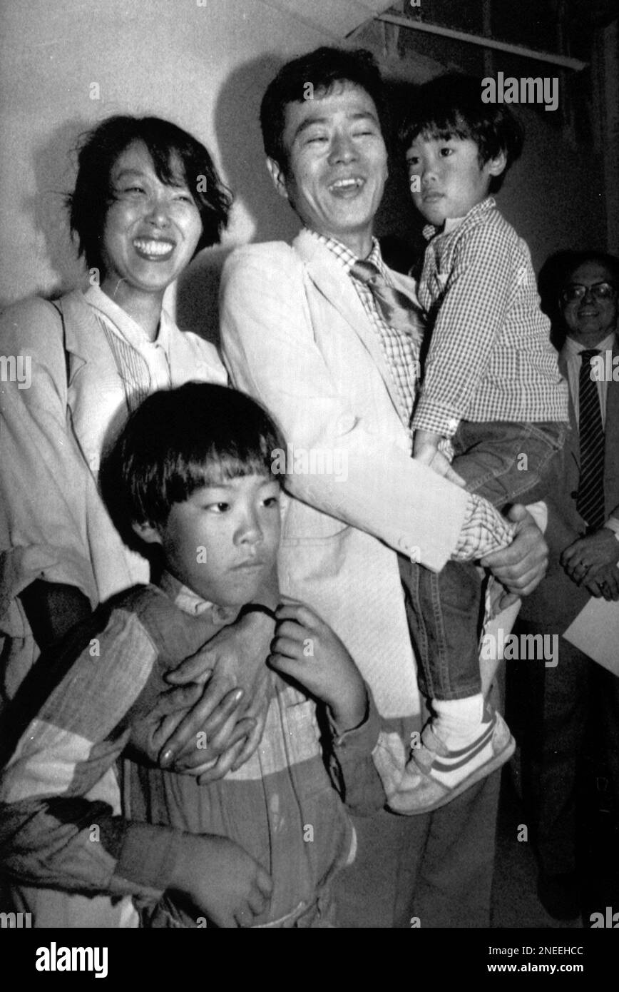 Japanese scholar Choichiro Yatani, 40, holds his 4-year-old son Will ...