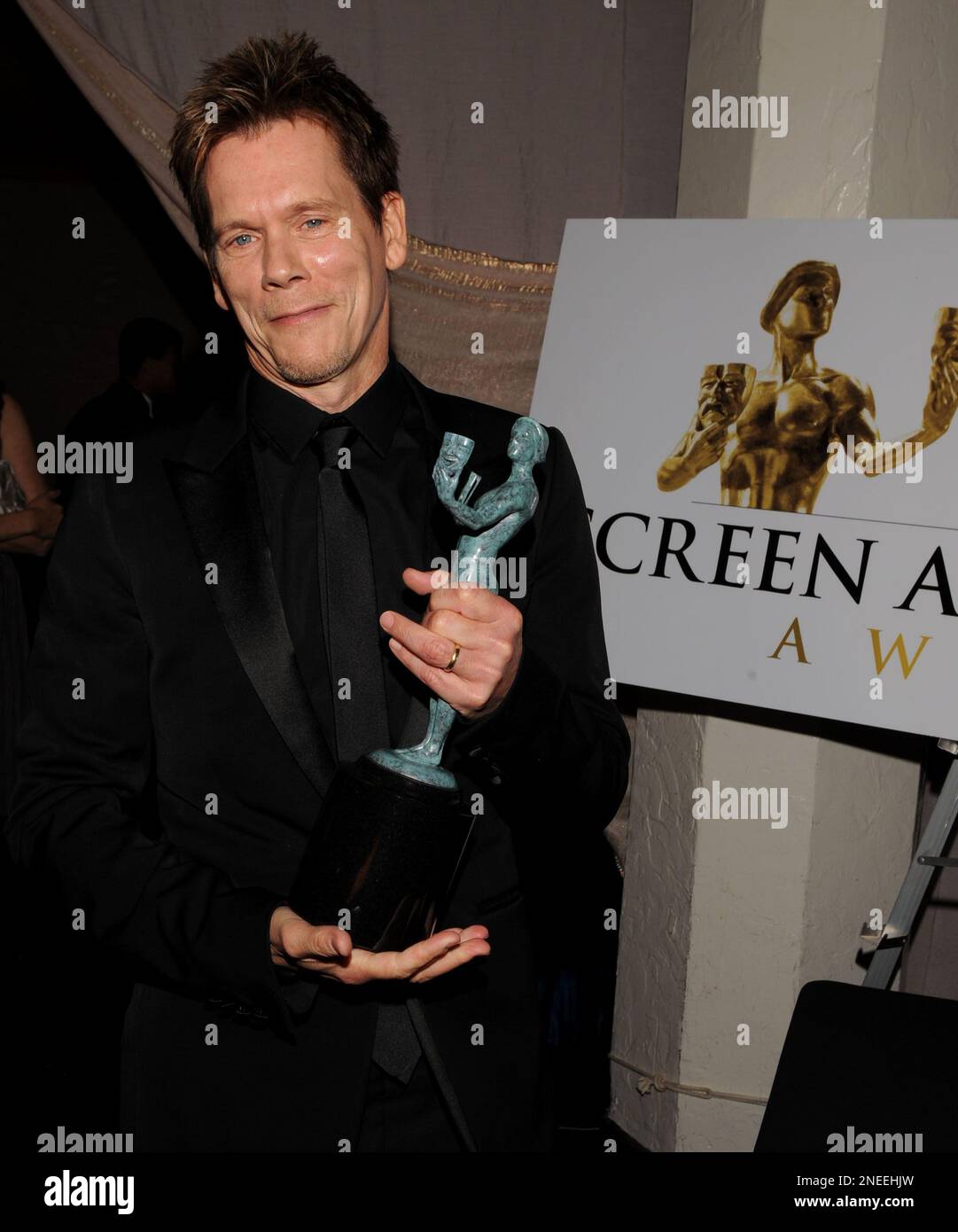 Actor Kevin Bacon poses backstage with the award for actor in a ...