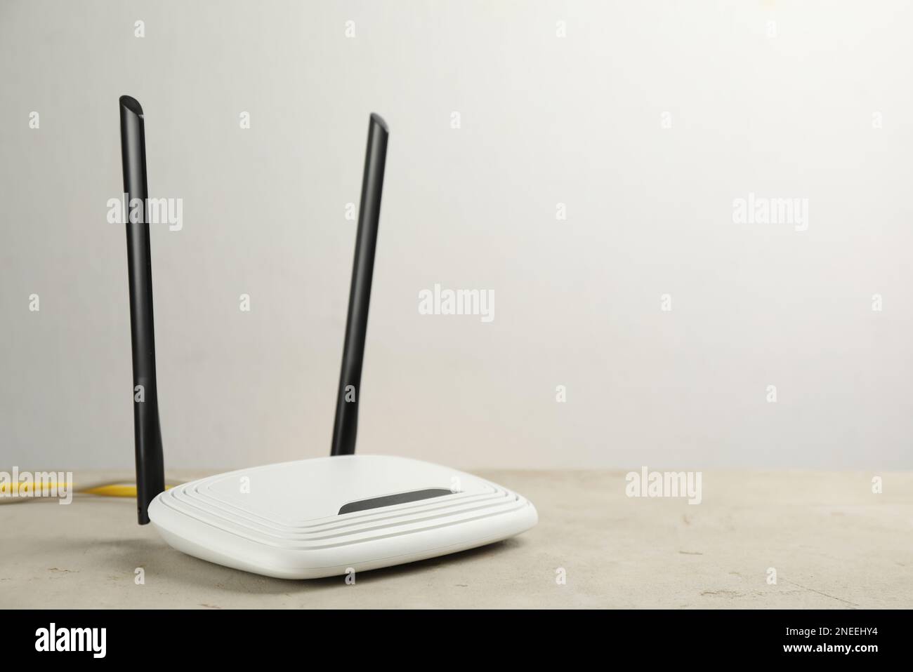 Modern Wi-Fi router on light table. Space for text Stock Photo - Alamy