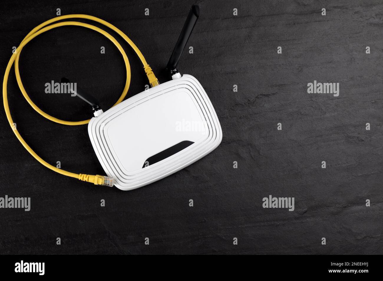 Modern Wi-Fi router on black background, top view. Space for text Stock ...