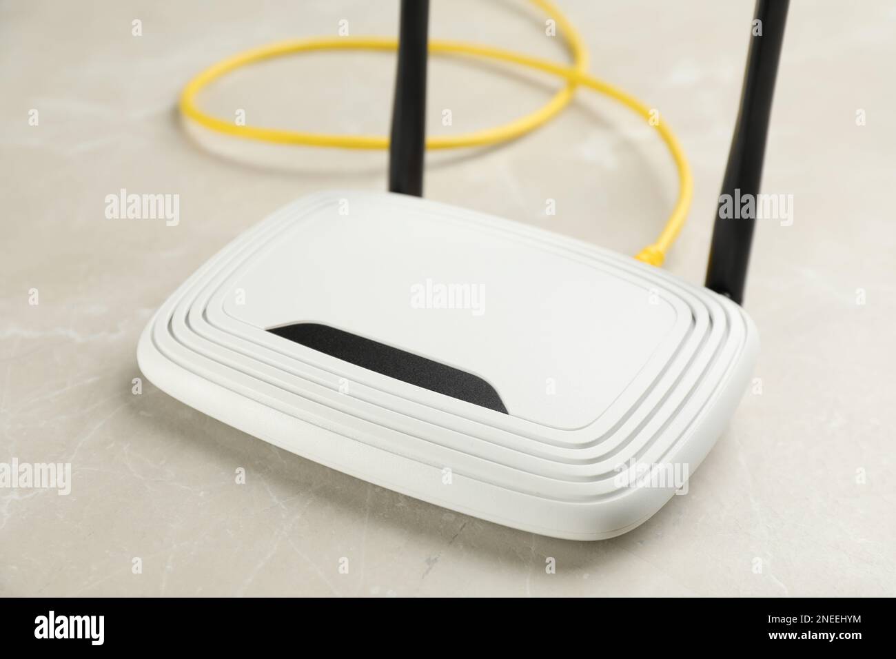 Modern Wi-Fi router on light grey marble background Stock Photo - Alamy