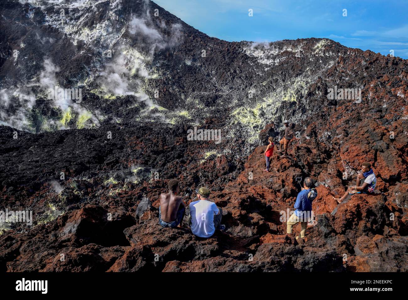 Hikers at the crater rim of the still active volcano Mount Tavurvur ...