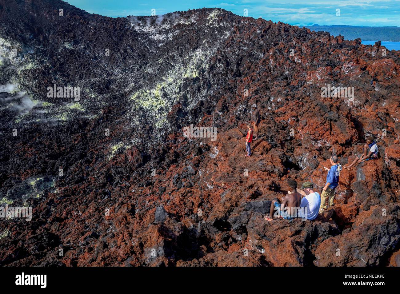 Hikers at the crater rim of the still active volcano Mount Tavurvur ...