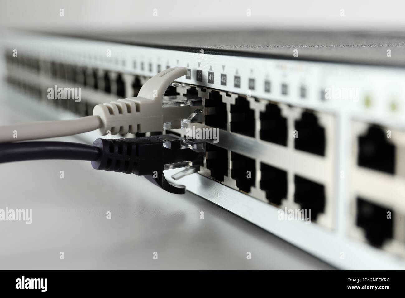Closeup view of network switch with cables on light background ...