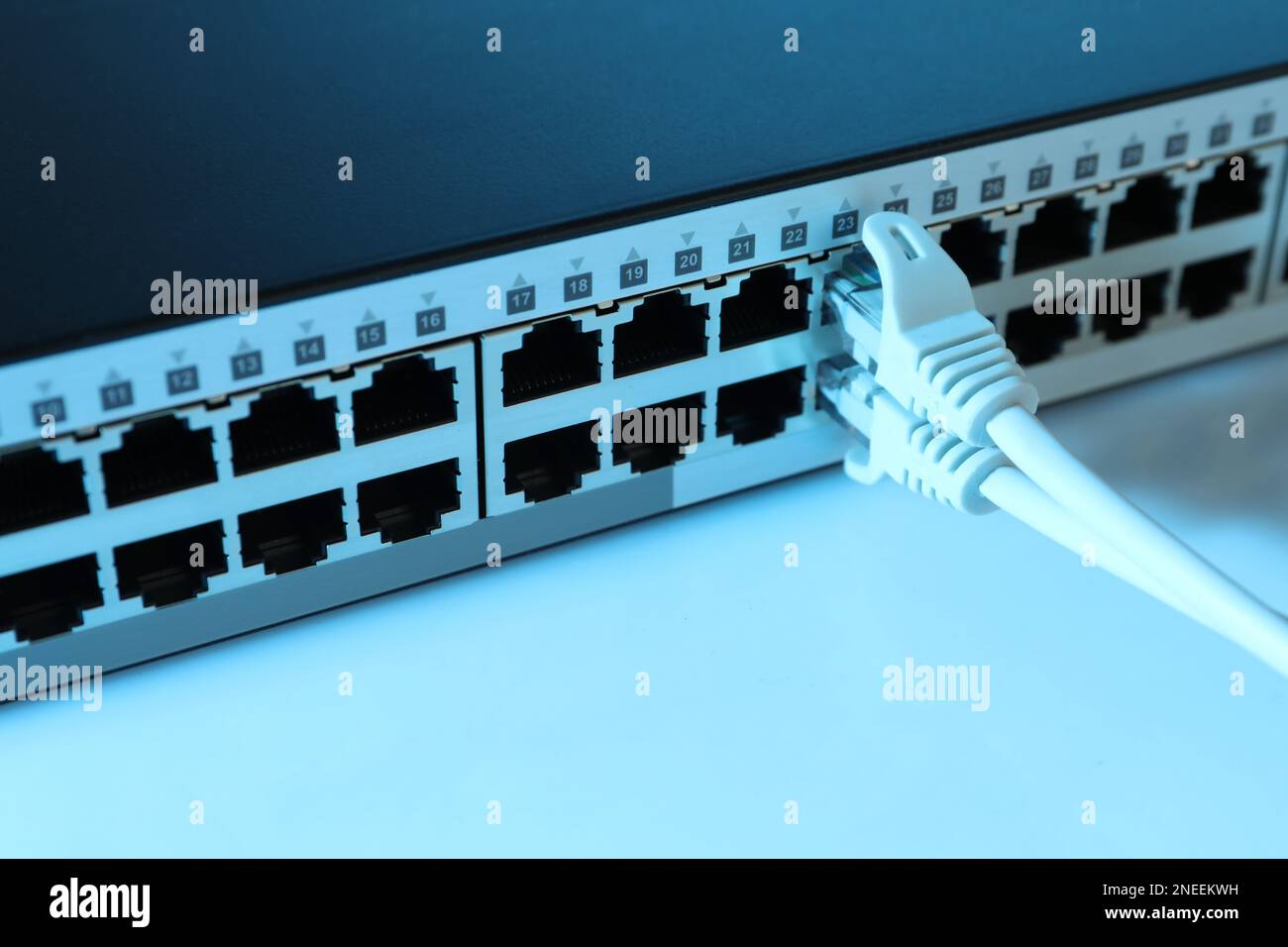 Closeup view of network switch with cables on light background, toned ...