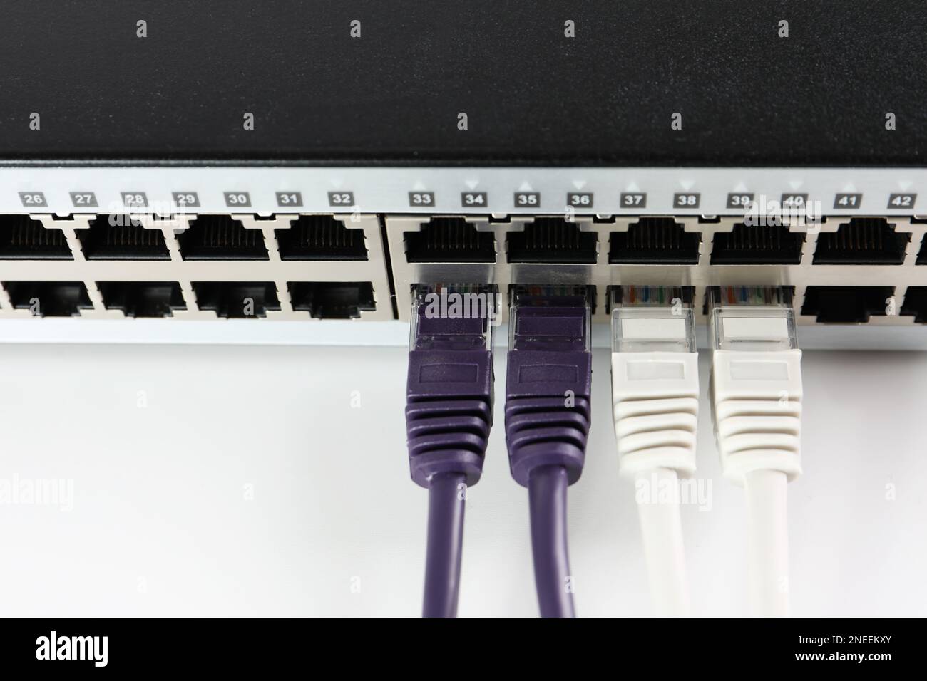 Closeup view of network switch with cables on light background ...