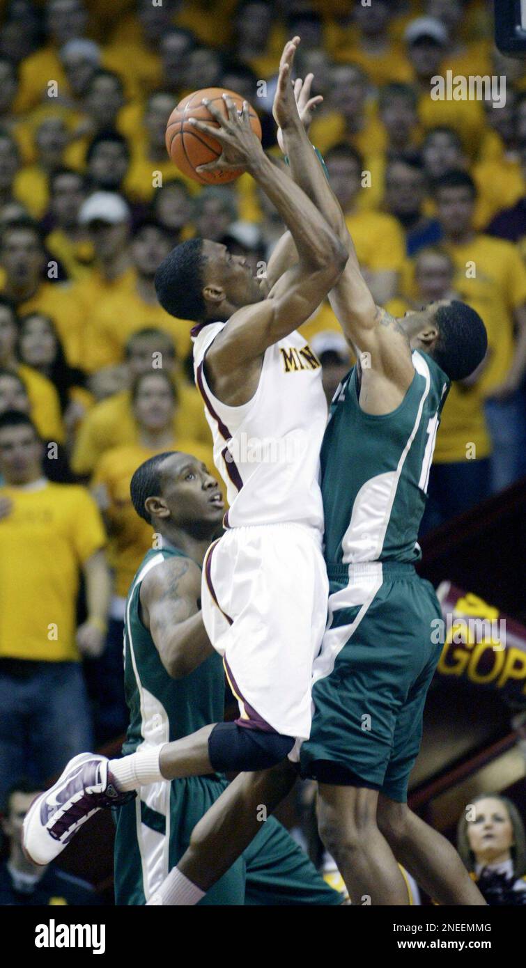 Minnesota forward Paul Carter, left, shoots against Michigan State ...