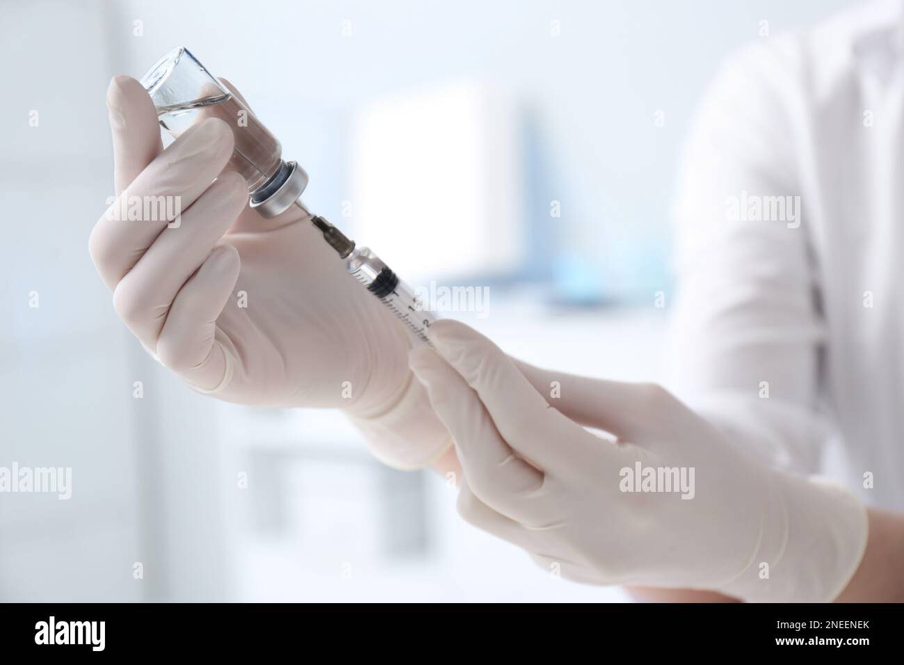 Doctor filling syringe with medication from vial in hospital, closeup ...