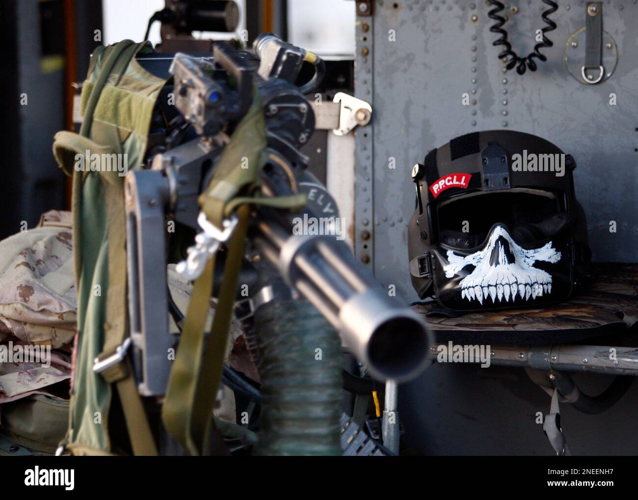 A decorated helmet is seen sitting alongside a Gatling M1-34 gun on a ...
