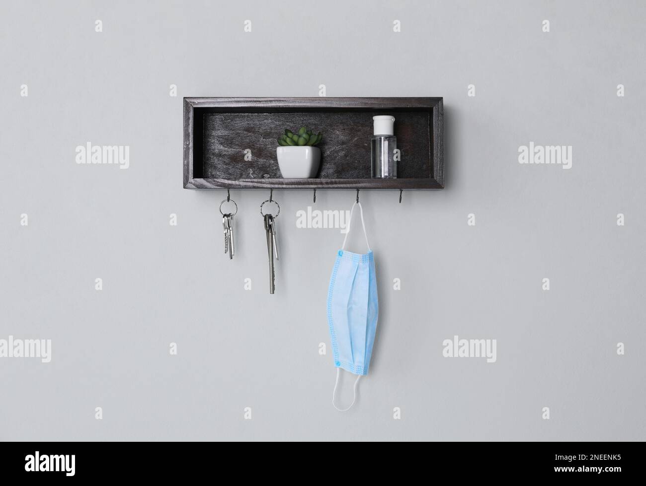 Wooden hanger for keys with different stuff on light grey wall Stock ...