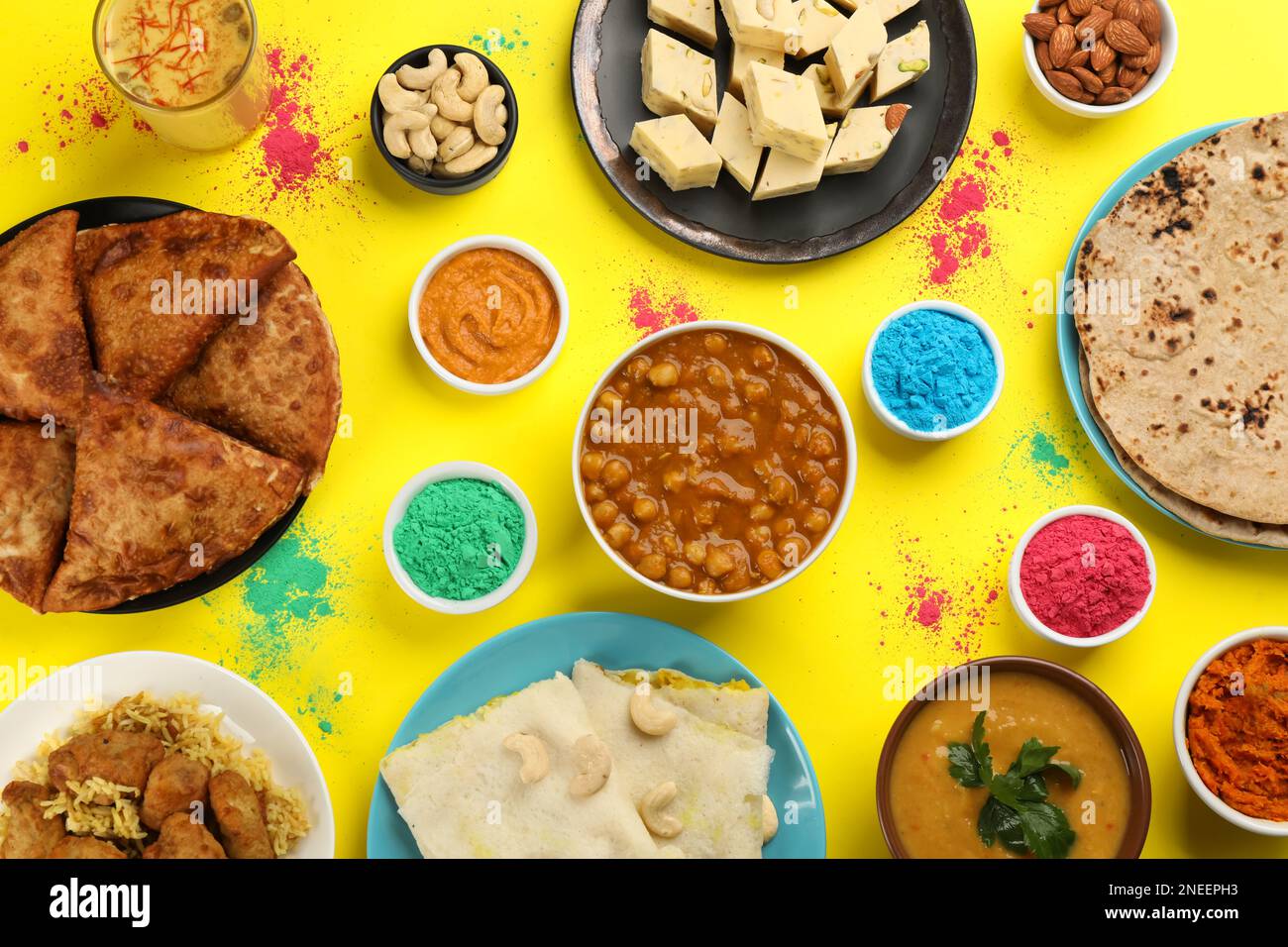 Traditional Indian food and color powders on yellow background, flat ...