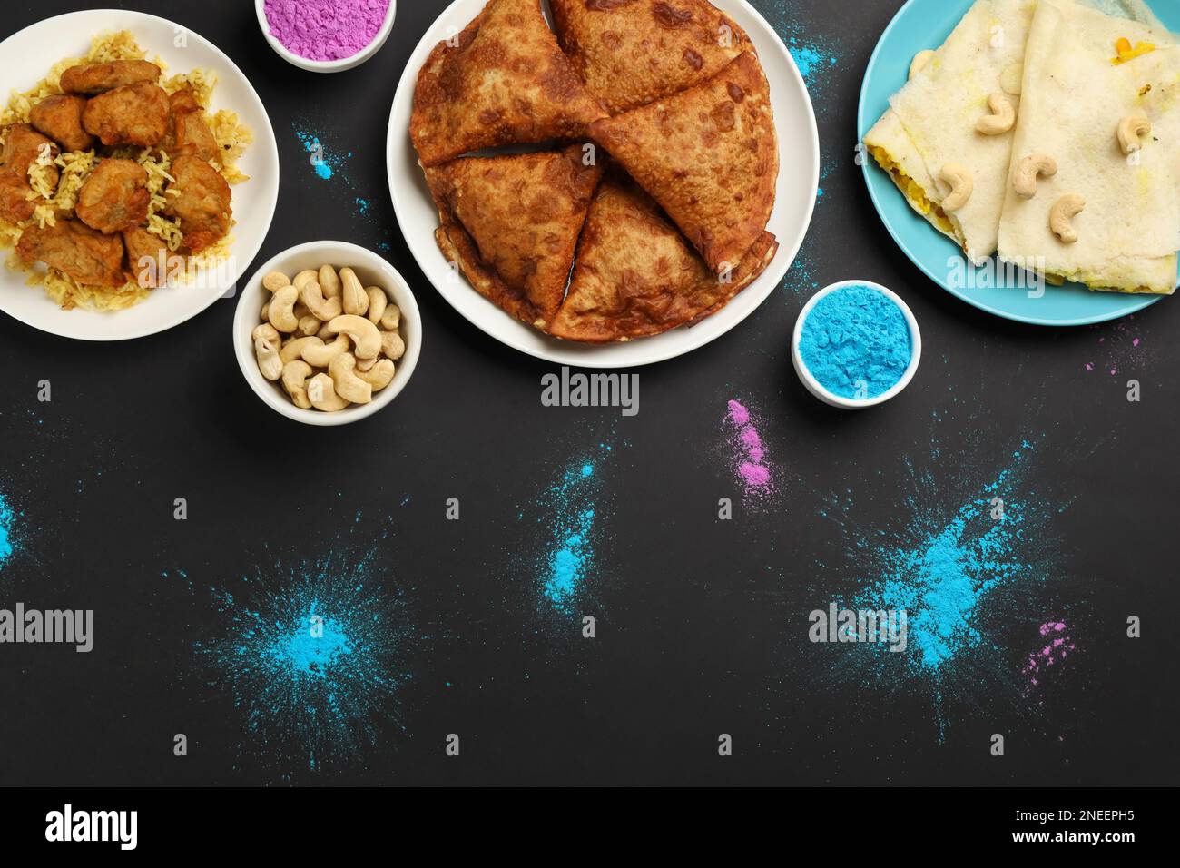 Traditional Indian food and color powders on black background, flat lay ...