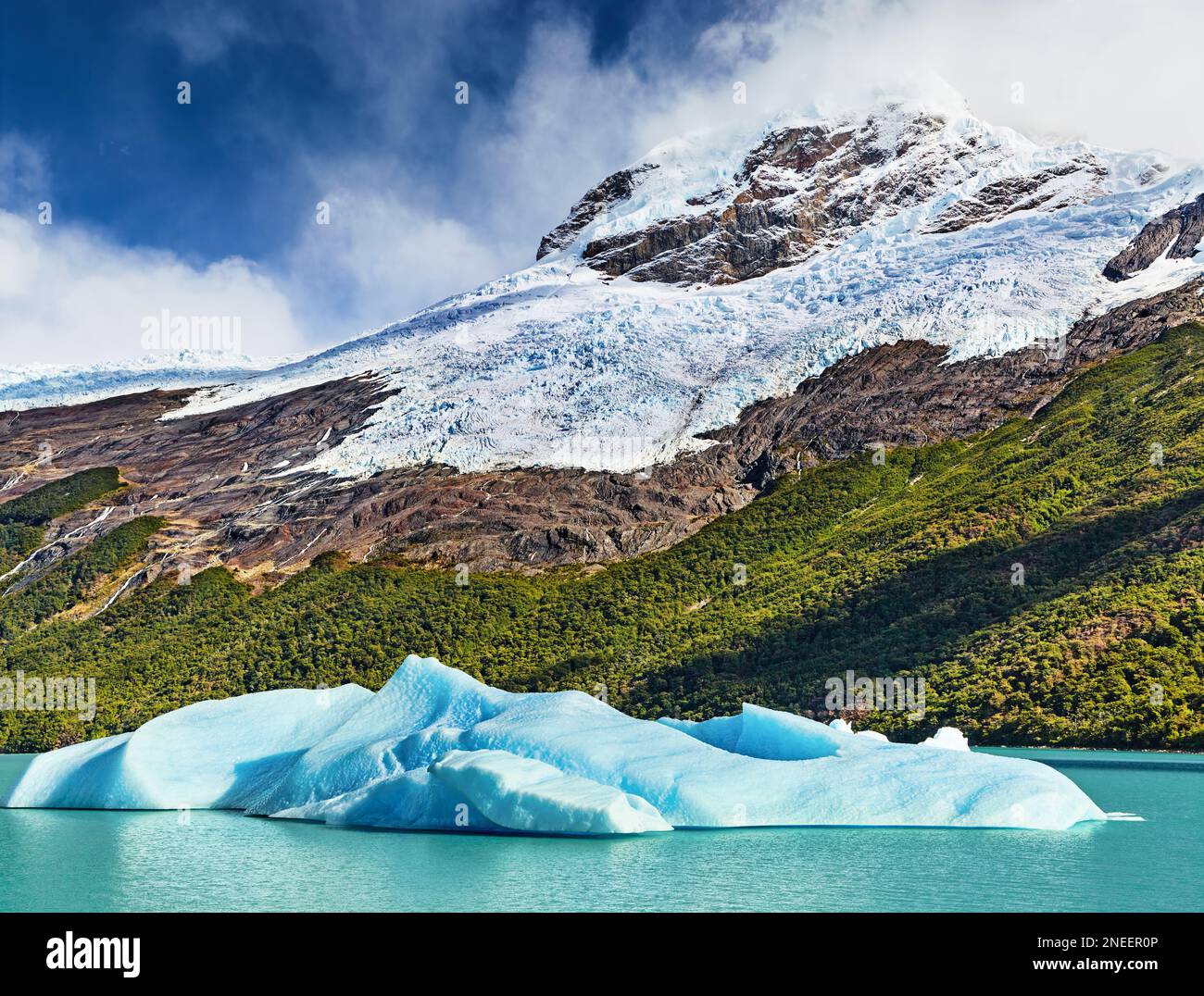 Floating ice floe and snowy mountains. Lake Argentino, the biggest freshwater glacial lake in ...