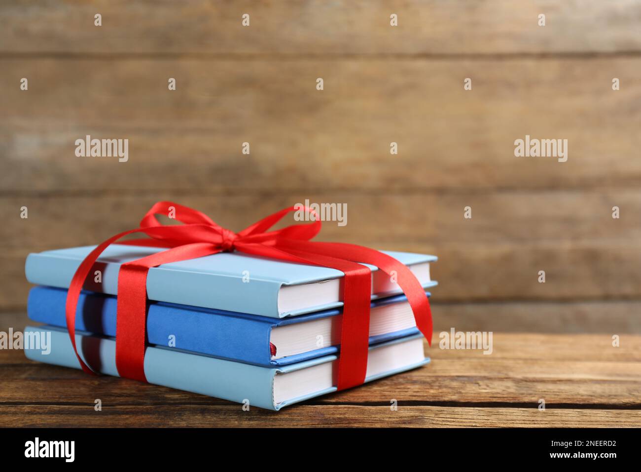 Books tied red ribbon hi-res stock photography and images - Alamy
