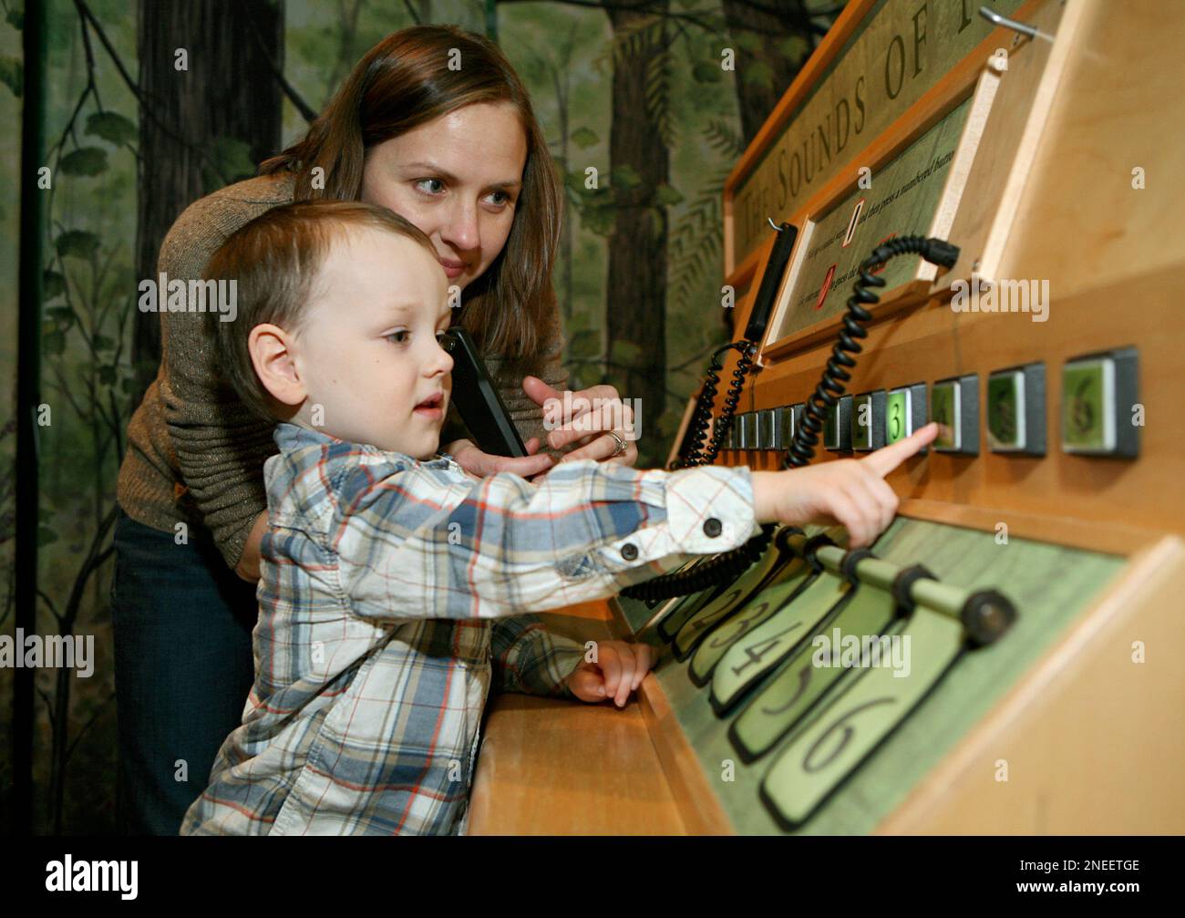 Miles Ritter and his mother Caroline Ritter listen to the sounds of ...