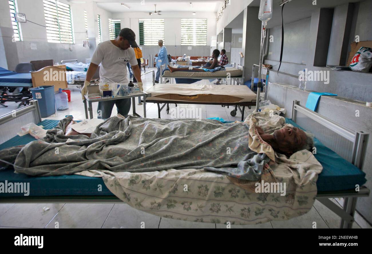 Marie Carida, 84, lies in a bed at the Hospital General in Port-au ...