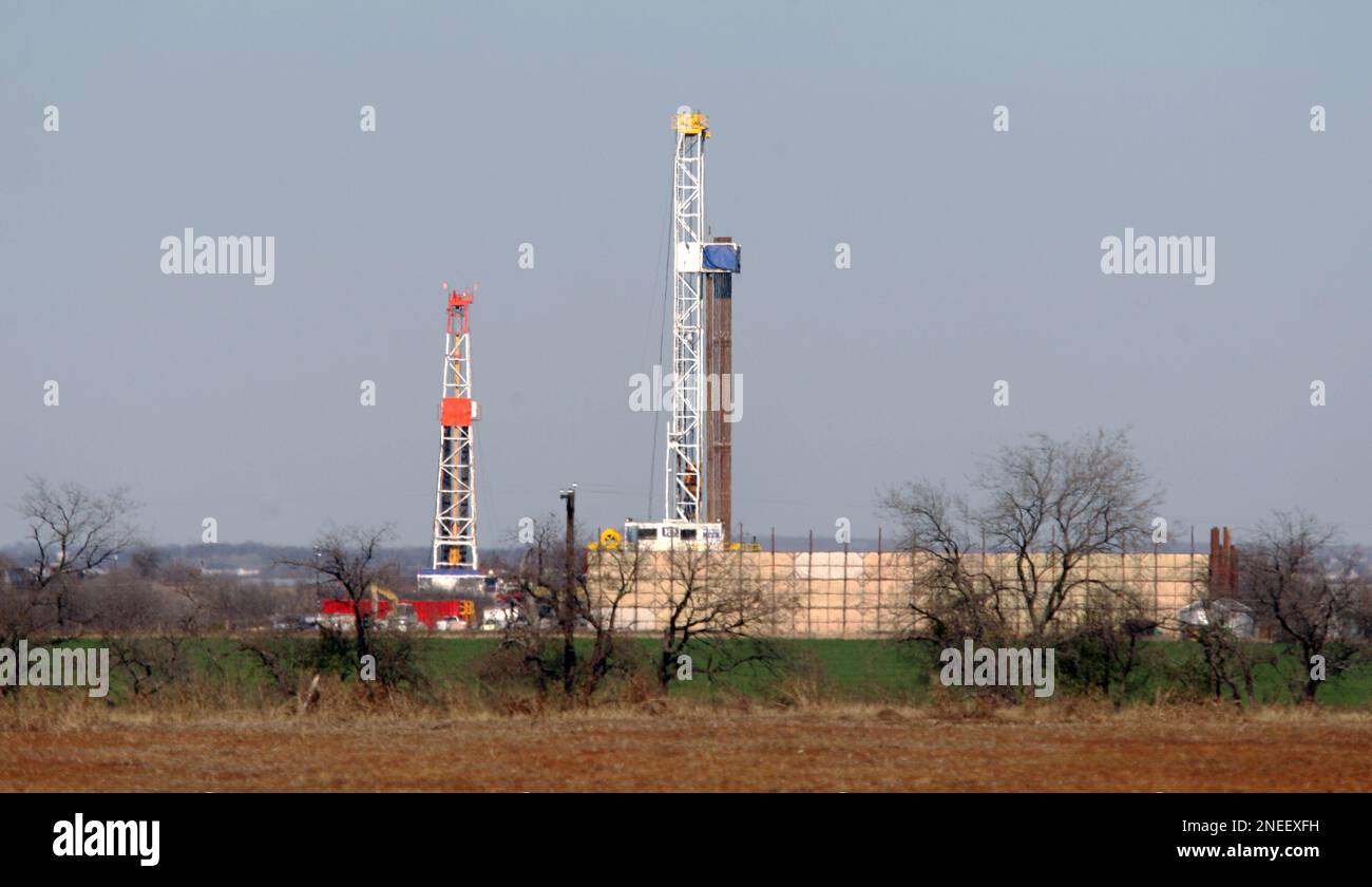 Two gas drilling rigs operate near Justin, Texas, Thursday, Dec. 10 ...