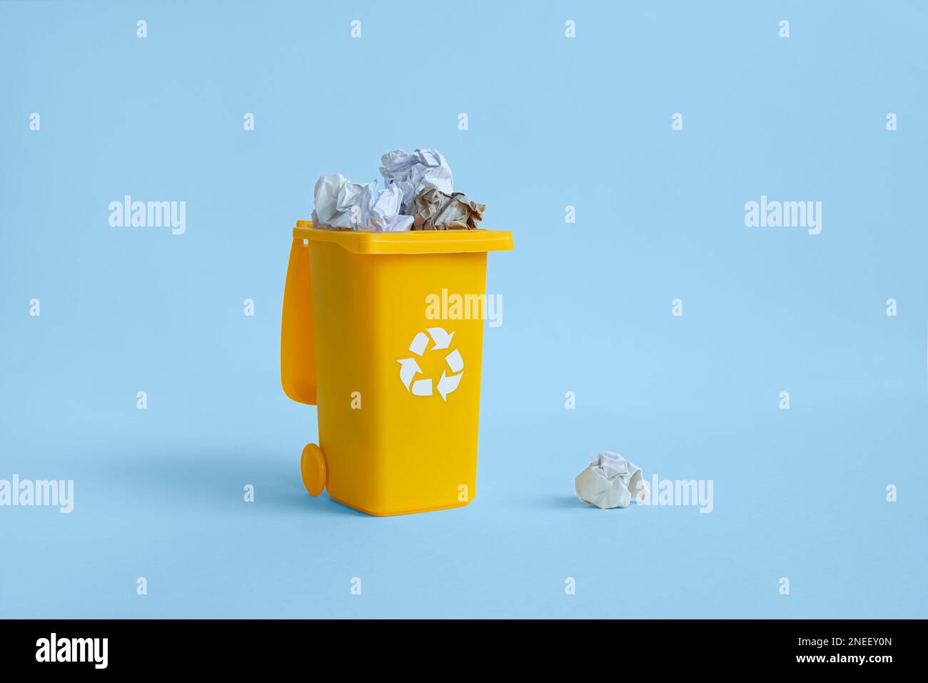 Opened yellow container for paper garbage collection with crumpled ...