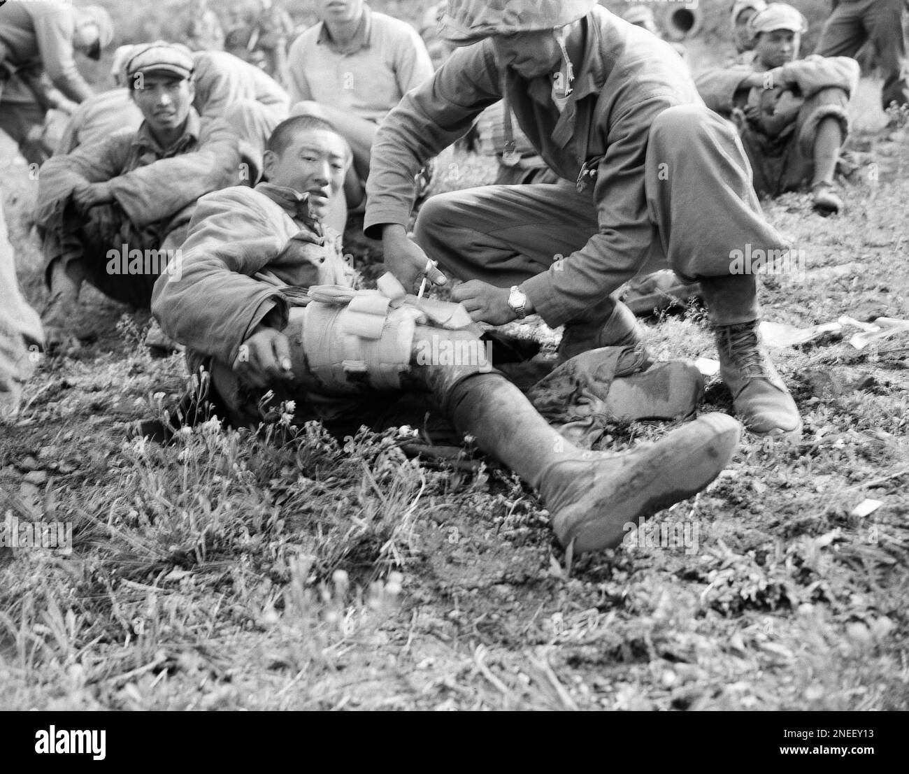Medics dress the wounds of Chinese Communist prisoners at a ...