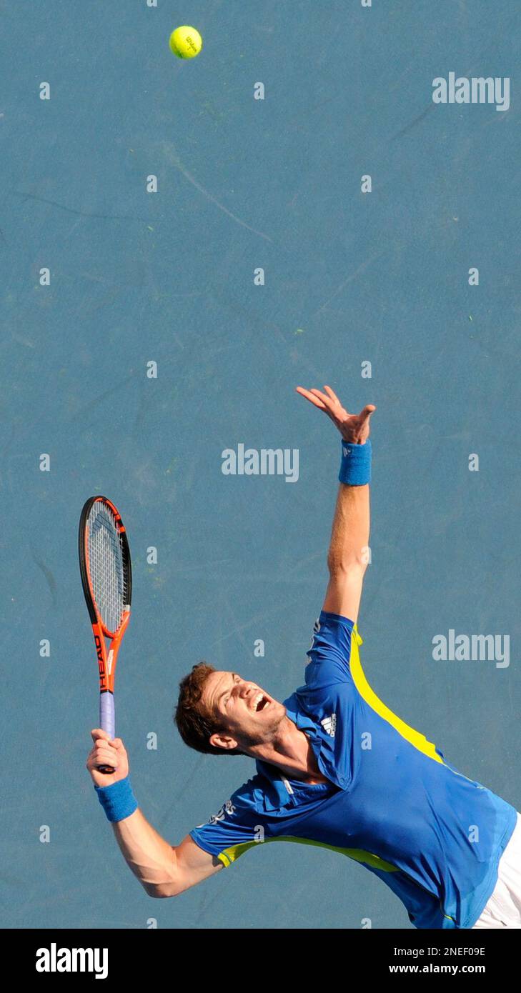 Andy Murray of Britain serves to Florent Serra of France during the Men ...