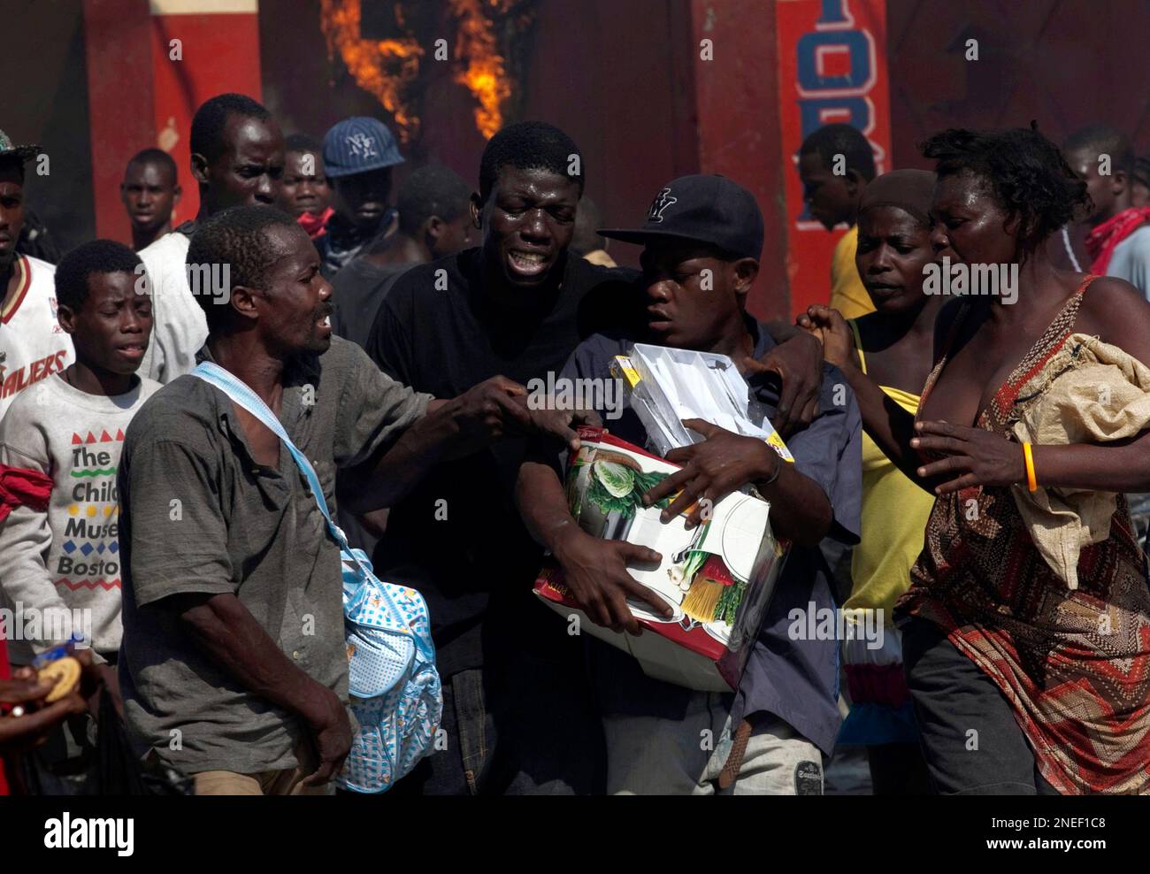 People fight over goods stolen from a store in downtown Port-au-Prince ...