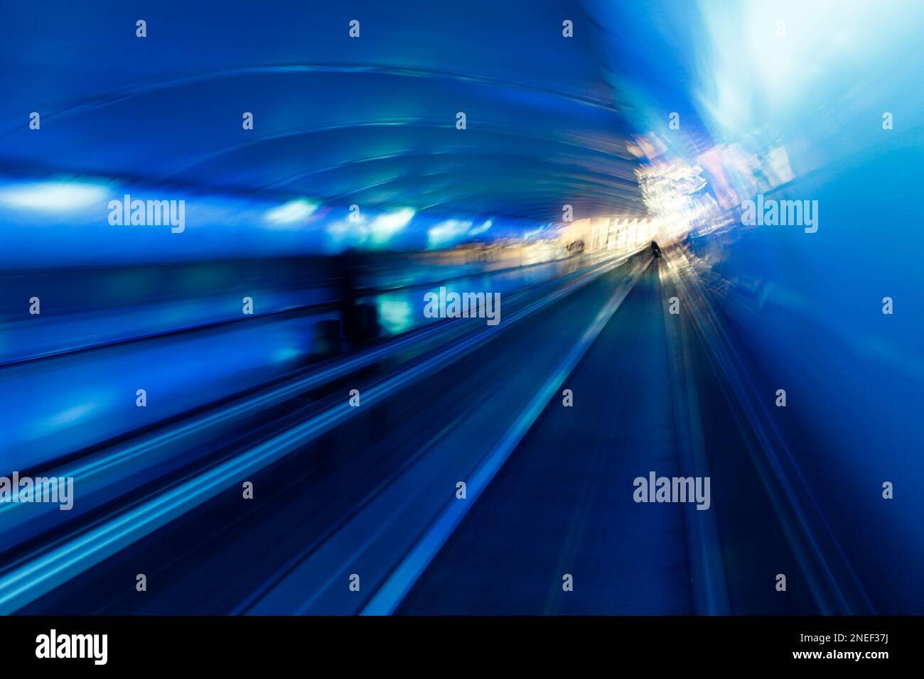 Passengers walk through a tunnel connecting terminals at Detroit ...