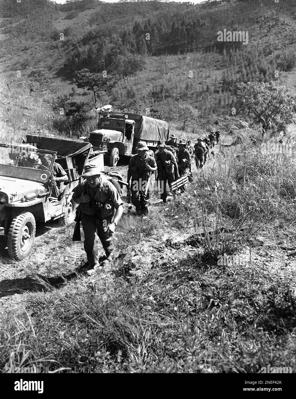 Men of the first commonwealth division trudge up a hill on the western ...