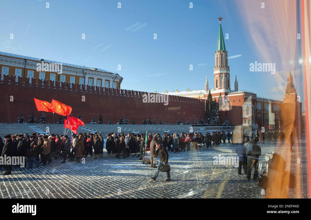Russian Communists carrying red flags queue to visit the Mausoleum of ...