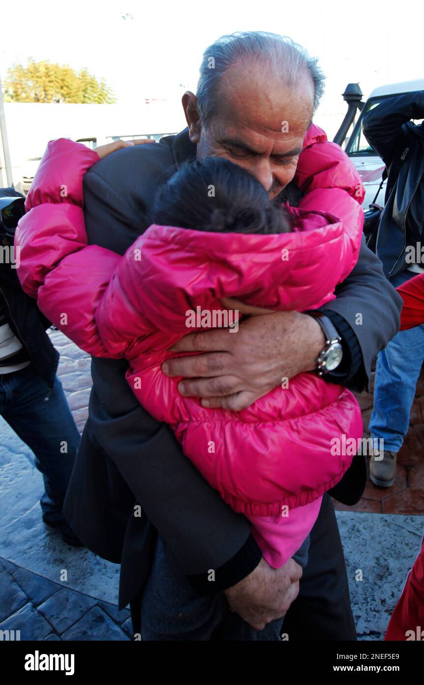 A Syrian man, hugs a young girl relative who is a survivor from the ...