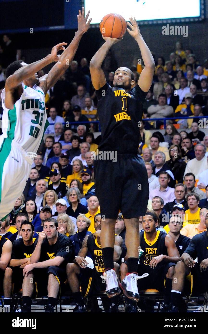 West Virginia's Da'Sean Butler shoots over Marshall's Tyler Wilkerson ...