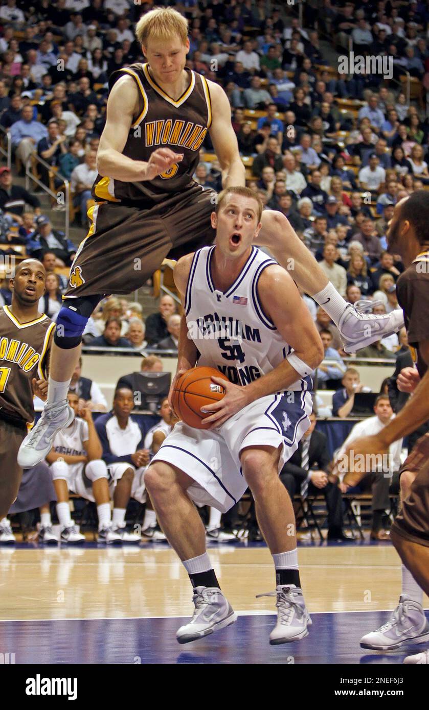 BYU's Chris Miles, is defended by Wyoming's Adam Waddell during the ...