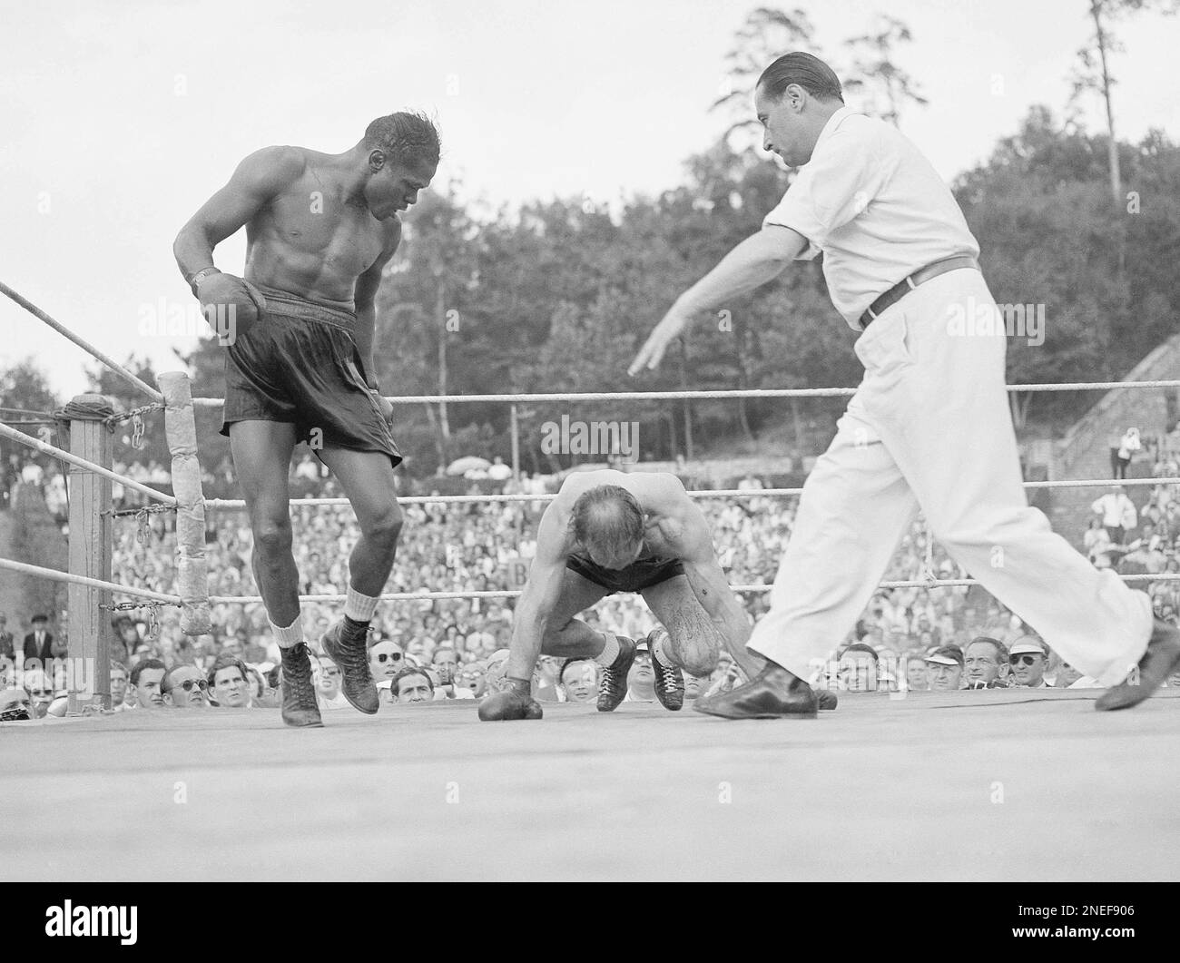 Lloyd Marshall, left, light heavyweight from Sacramento, Calif., proceeds to a neutral corner ...