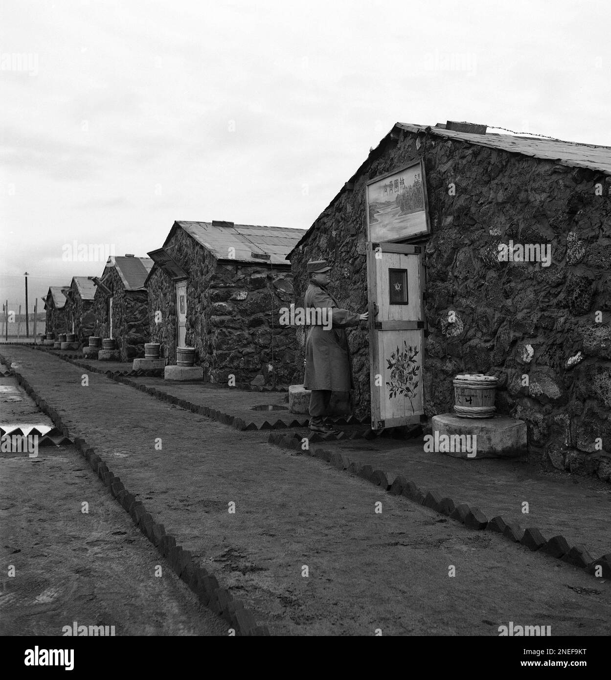 Lt. John Jancook, Box K, LaGrange, Ky., opens painted door of hut in ...