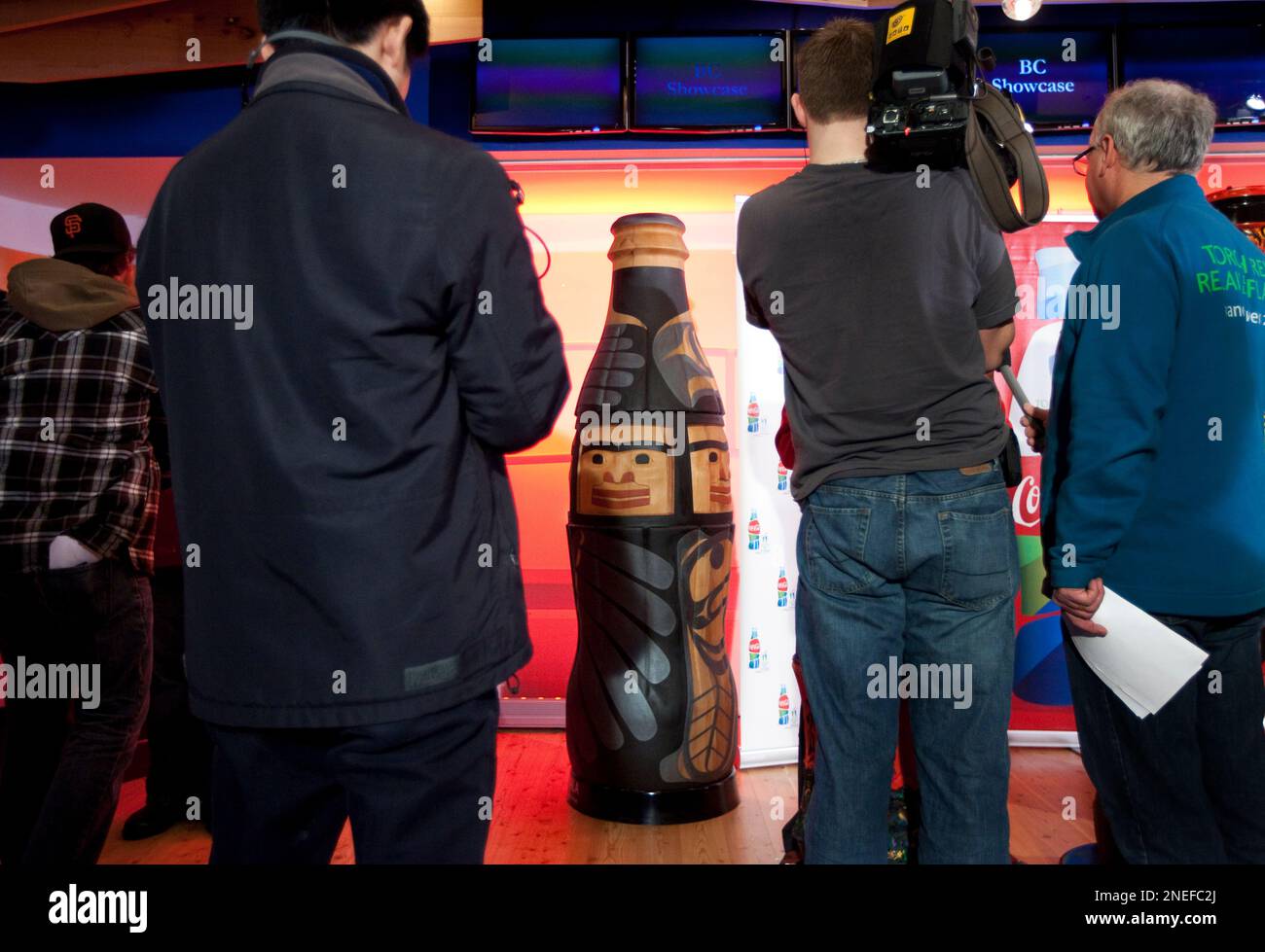 Members of the media surround a solid wood Coca-Cola Aboriginal Art ...