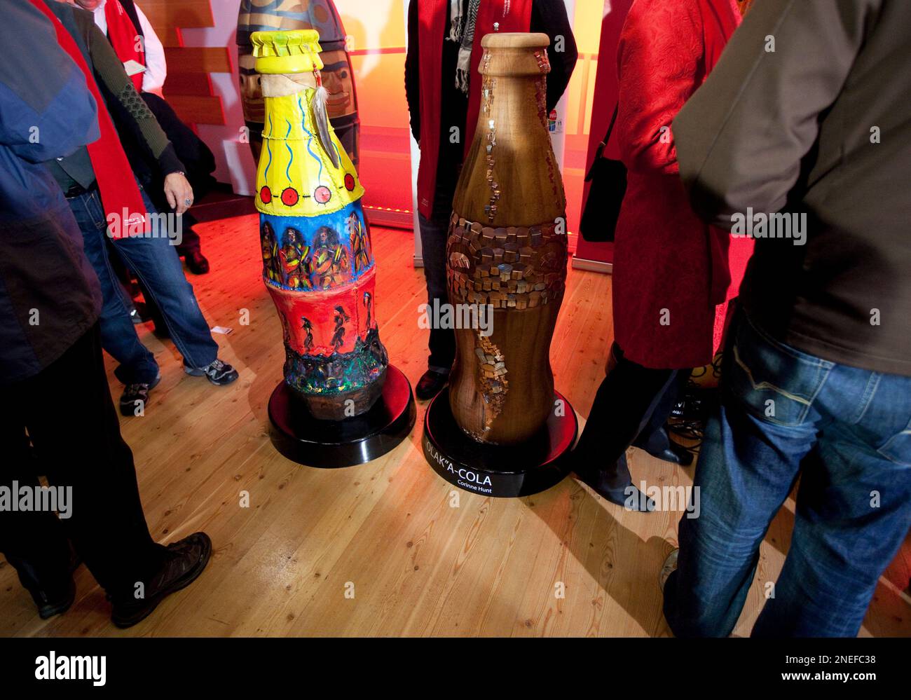 Members of the media surround a solid wood Coca-Cola Aboriginal Art ...