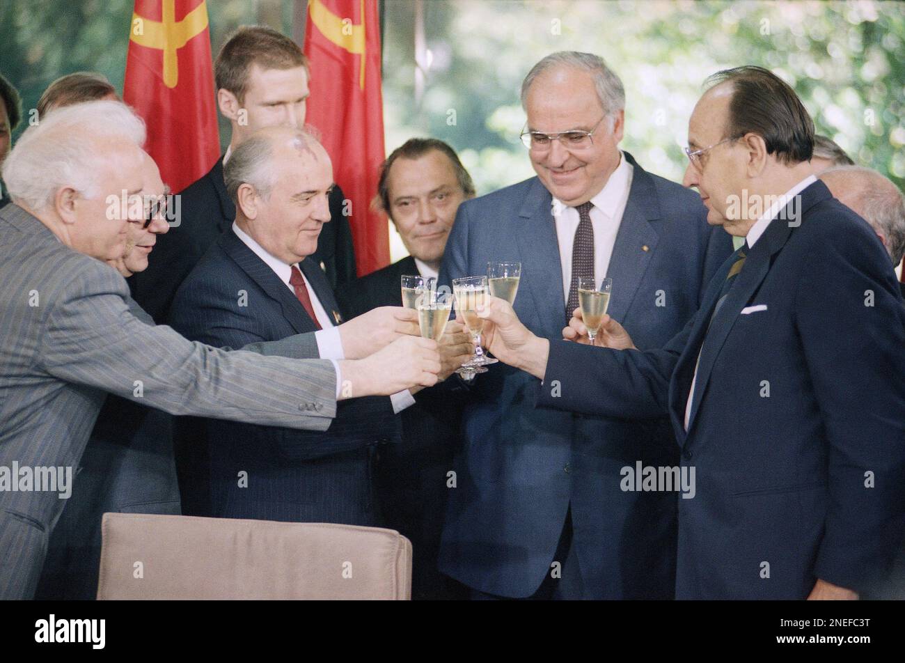 Soviet and West German leaders clink glasses with champagne after ...