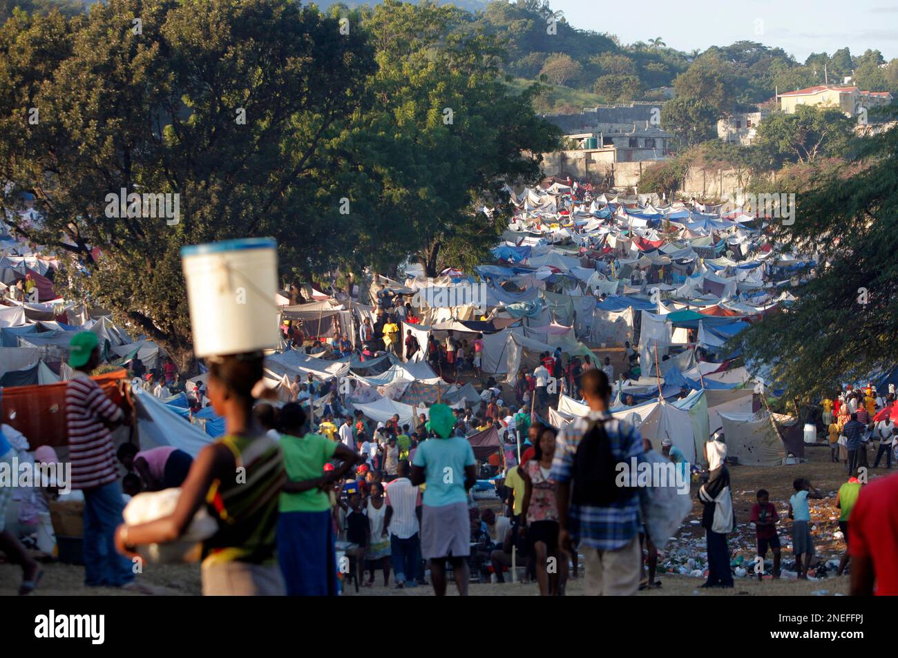 People crowd at a makeshift camp for earthquake survivors set up on a ...