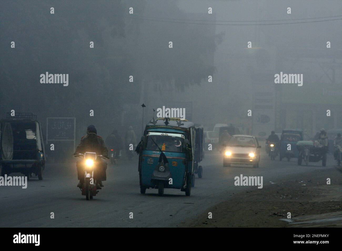 Motorists drive with headlights on as fog envelopes Sargodha, Pakistan ...