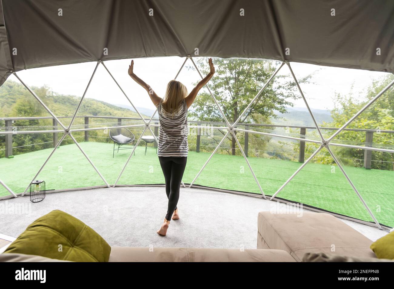 a woman enjoys solitude inside of a transparent bubble hotel Stock ...