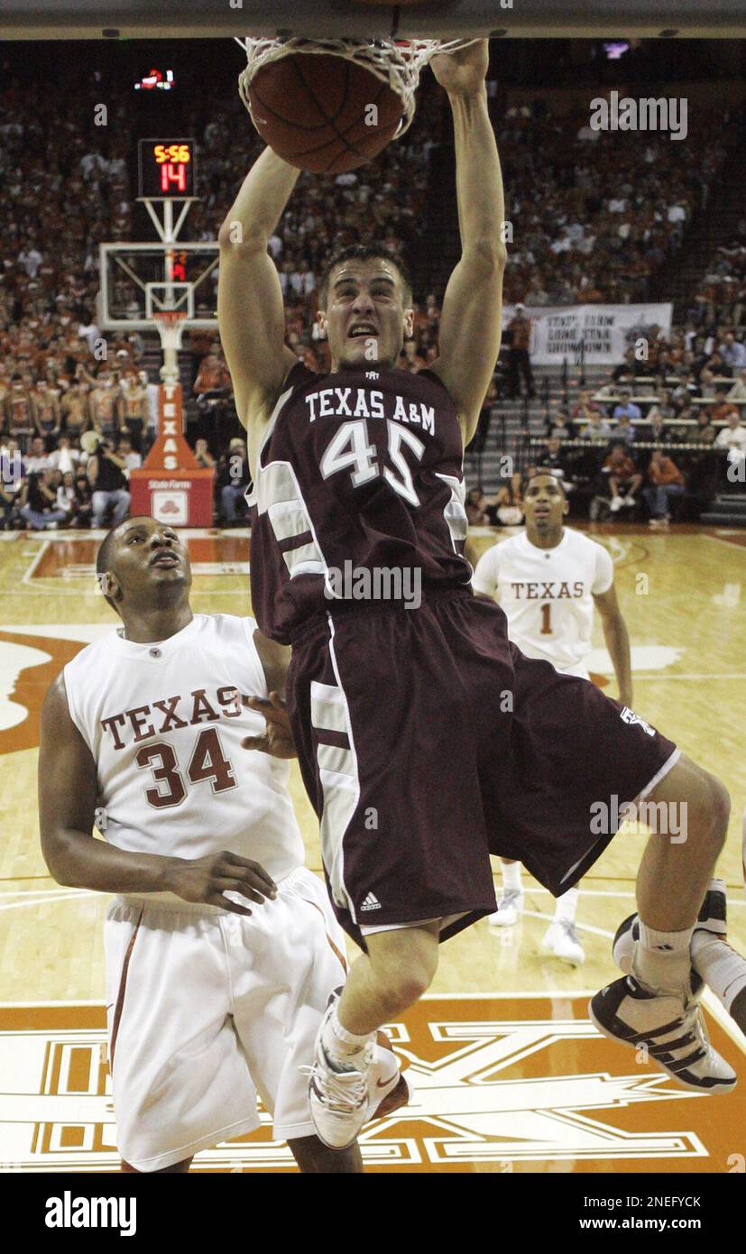 Texas A&M forward Nathan Walkup (45) dunks in front of Texas center ...