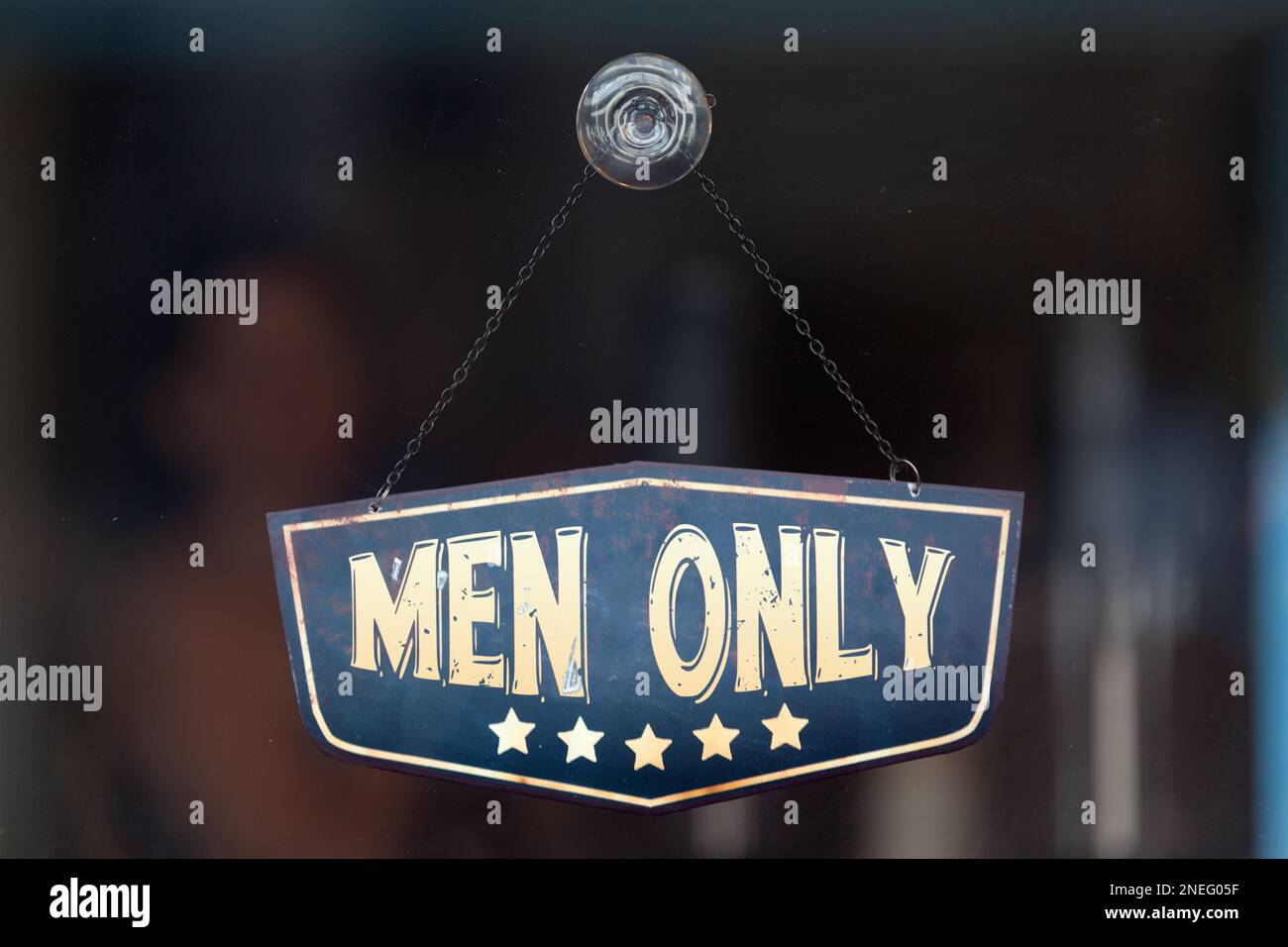 Old fashioned sign in the window of a shop saying in "Men only Stock ...