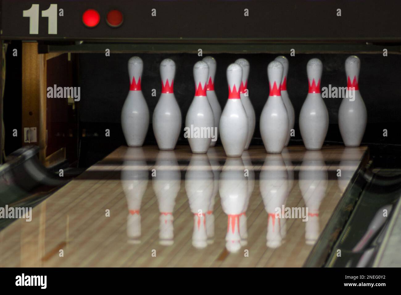 Close up on bowling pins with their reflection on the bowling alley ...