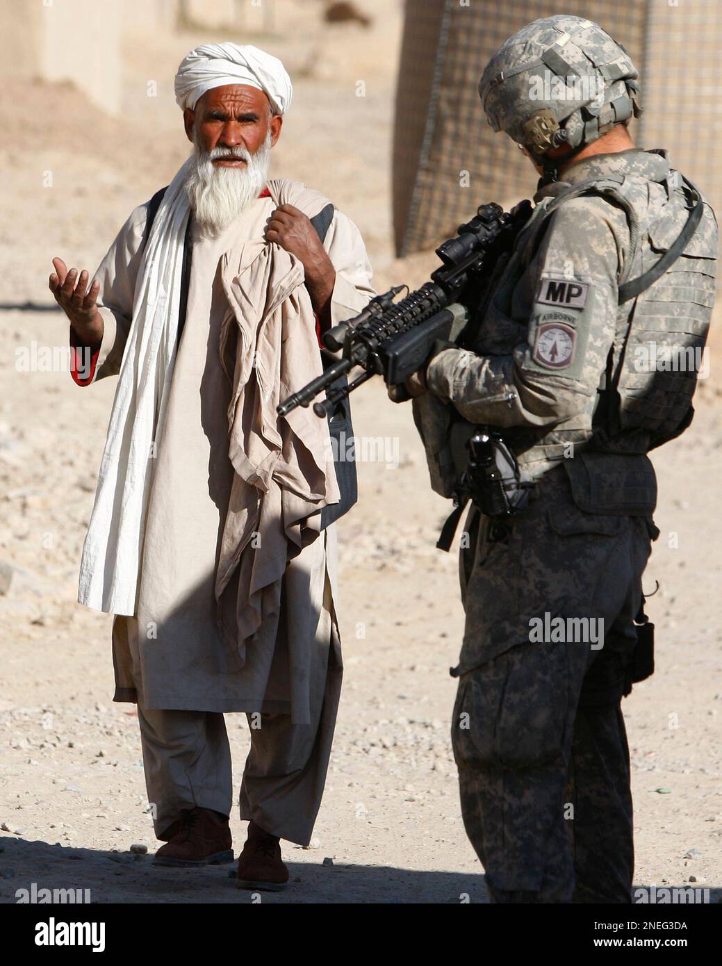 A local man talks to a soldier of 293rd Military Police Company out of ...