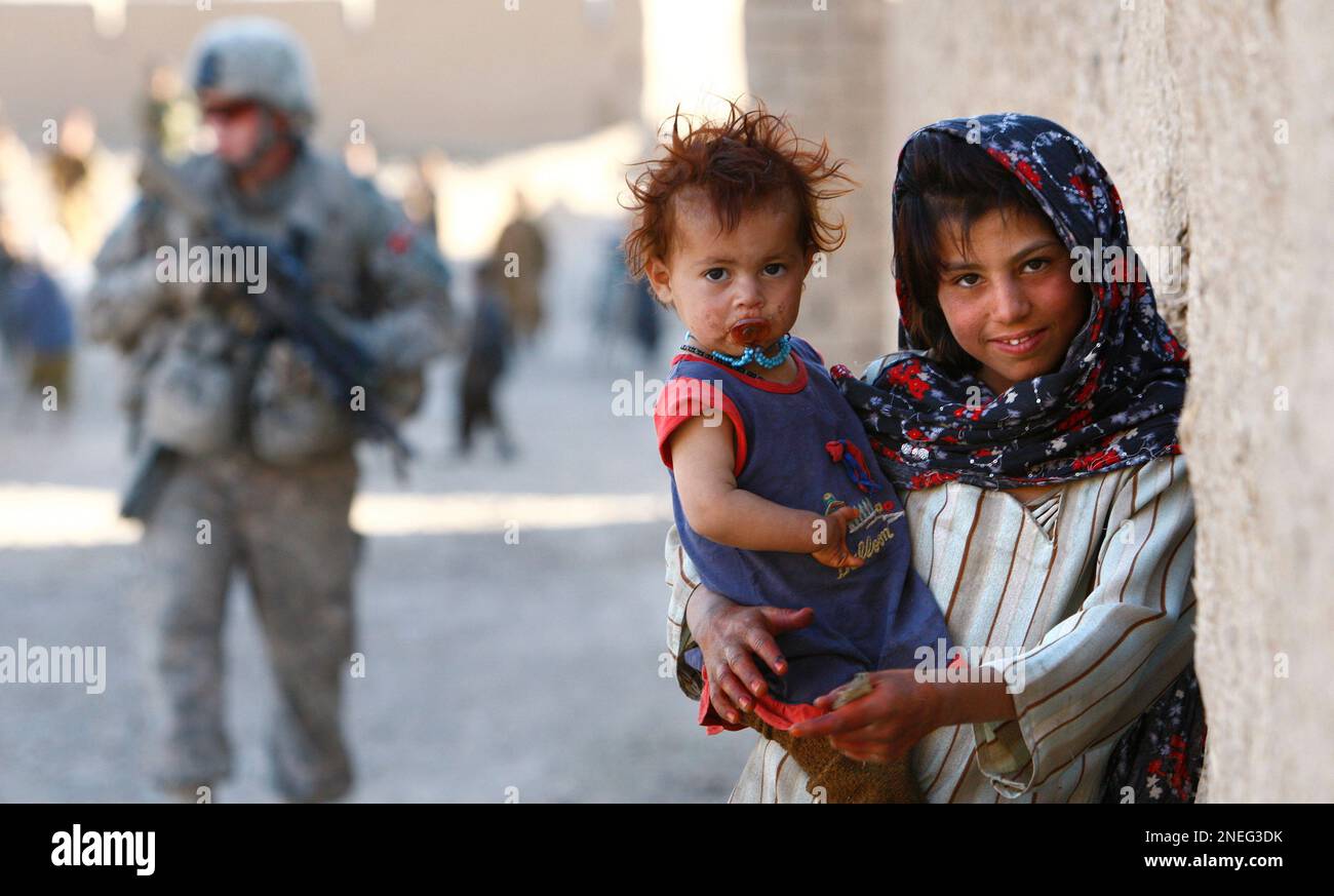 Local children smile for a picture as 293rd Military Police Company ...