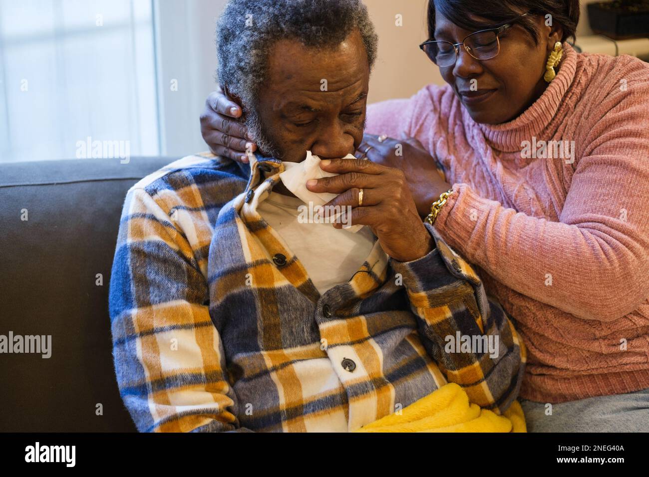 Sick man cared for by his wife to get well soon from the flu. Concept ...