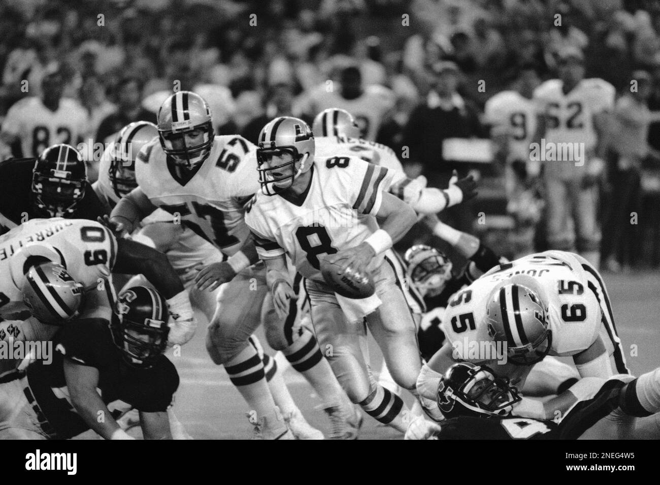 Los Angeles Express quarterback Steve Young (8) breaks through the line ...
