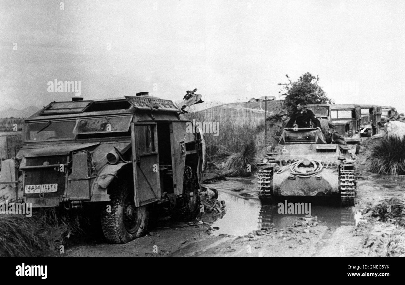 German tanks and trucks passing one of the many destroyed British ...