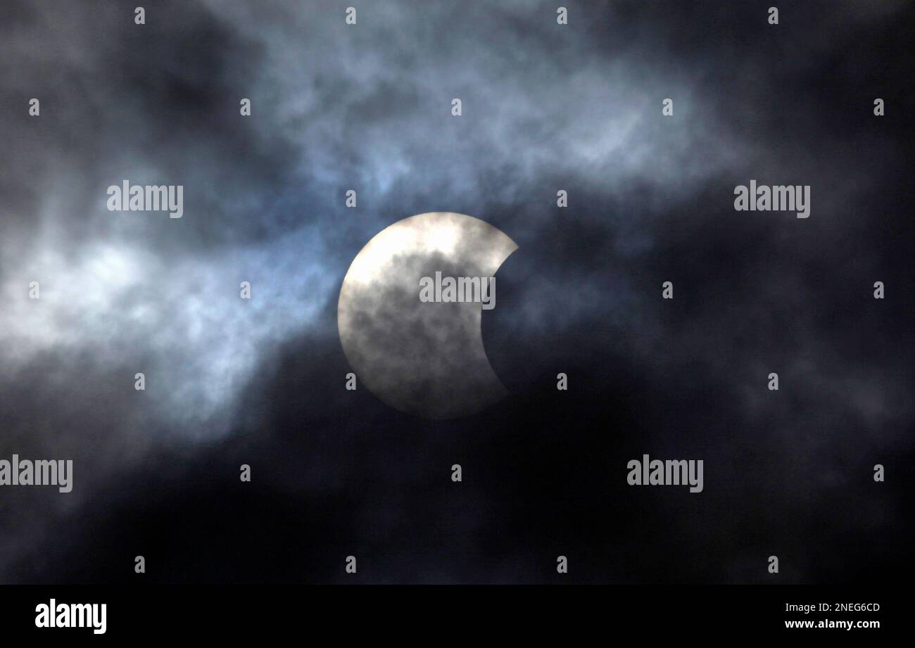 The sun is partially blocked by the moon during a solar eclipse seen ...