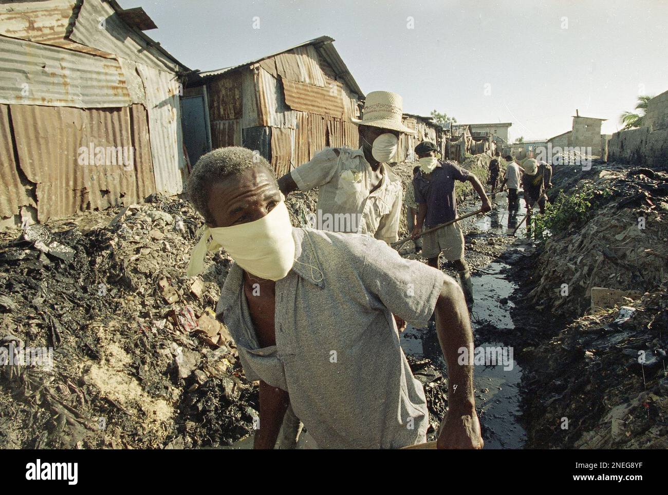 Employees of the city of Port-au-Prince attempt to dredge a canal ...